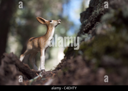 Small deer figurine in woods Stock Photo - Alamy
