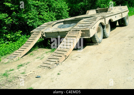 Transportation on platform of heavy machinery. Yellow tractor ...