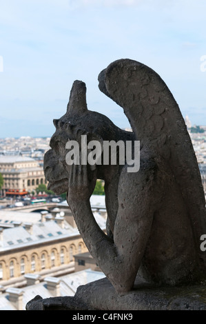 Gargoyle Stryge and demon at Notre Dame of Paris overlooking the ...