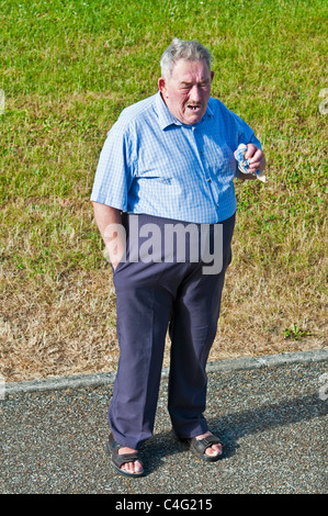Overhead view of stocky, older man standing on pavement - France Stock ...