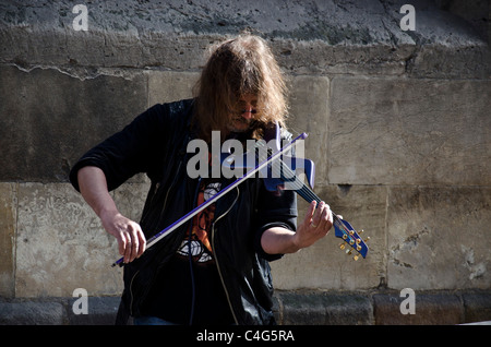 Electric-violin-playing busker in York City Centre, England Stock Photo ...