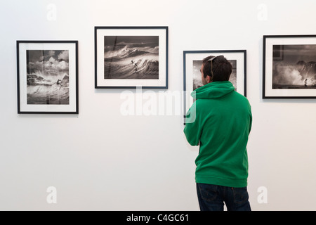 Man viewing the Ed Freeman Photography Gallery opening of his new ...