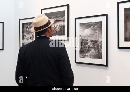 Man viewing the Ed Freeman Photography Gallery opening of his new ...