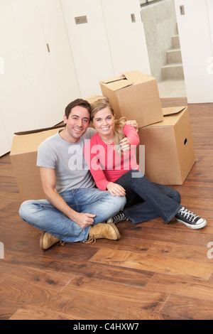 Happy young couple with cardboard boxes in room on moving day Stock ...