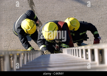 Firefighter carrying hoses during a fire at a hotel in East London ...