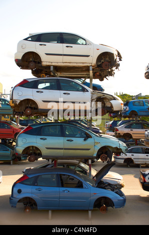 Old smashed up cars stacked high in breakers yard Stock Photo - Alamy