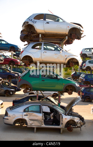Smashed and wrecked cars of green and silver color on the parking lot ...