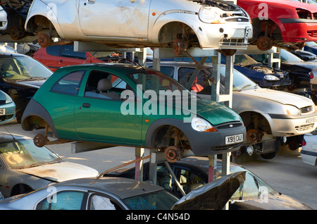 Old smashed up cars stacked high in breakers yard Stock Photo - Alamy