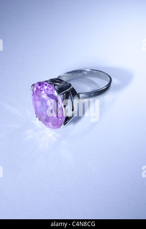 One violet blue shiny gemstone in air on white background Stock Photo ...