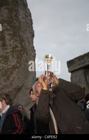 A reveler at the ancient stone circle Stonehenge to celebrate the ...