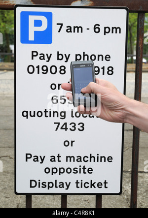 A Pay To Park By Mobile Phone sign on a parking meter in a Glasgow city ...