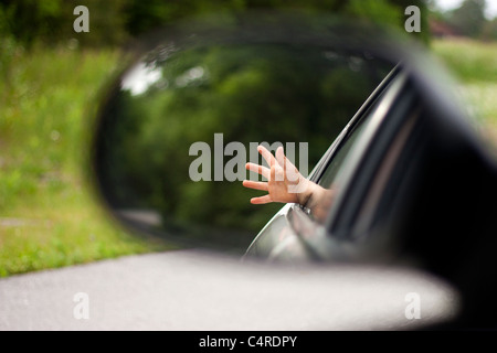 Boys hand outside moving car window Stock Photo - Alamy