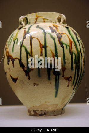 Tri-colored glazed pottery of the Tang Dynasty on a white background ...