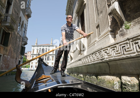 Gondola boatman rowing down canal, Venice, Italy Stock Photo - Alamy