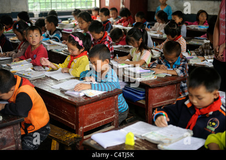 Chinese primary school students attending class at a poor village in ...