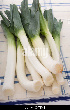 High angle close-up of leeks on wooden table Stock Photo - Alamy
