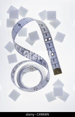 White sugar cubes and measuring tape on white table Stock Photo - Alamy