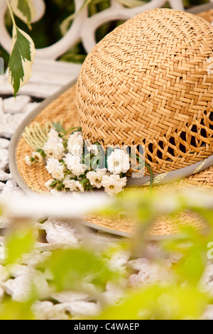 Straw hat on garden chair Stock Photo - Alamy