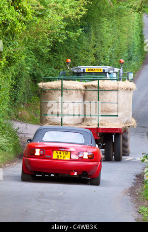 Cars stuck behind a tractor on a road in Gloucestershire UK Stock Photo ...