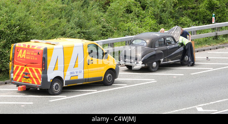 AA recovery van and mechanic at a broken down car in the UK. AA Stock ...