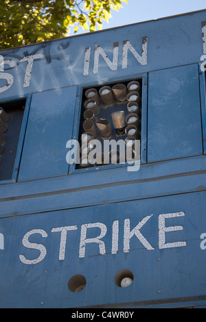 A close-up image of a red scoreboard with the words 'Home' and 'Guest ...