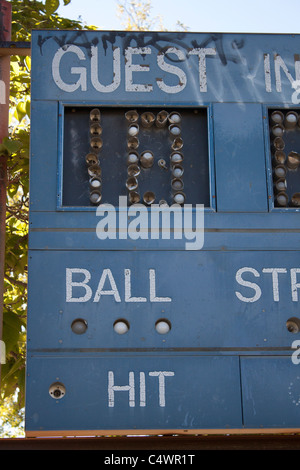 A close-up image of a red scoreboard with the words 'Home' and 'Guest ...