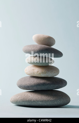 Vertical shot of stacked rocks on the shore of a lake under the ...