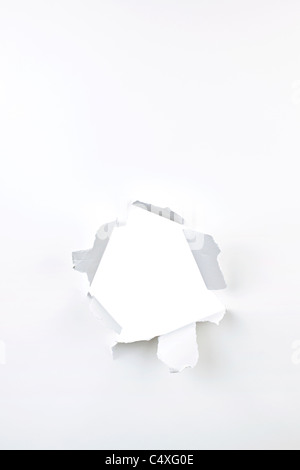 ripped hole in textured white paper on orange background Stock Photo ...