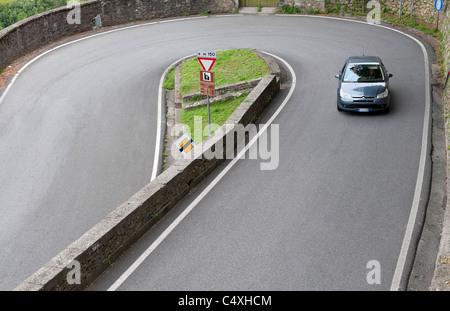 Car driving uphill on the twisting and turning switchback road through ...