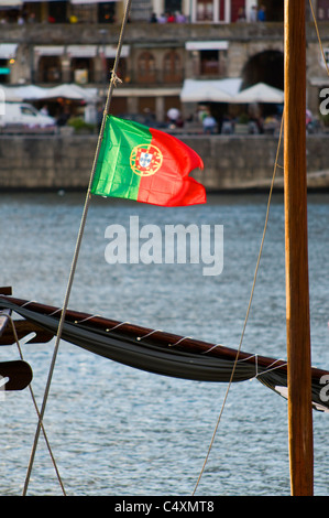 Portuguese flag flying in wind with stormy Atlantic Ocean waves ...