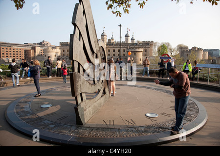 Sundial at Tower Hill Underground Station with the Tower of London in ...