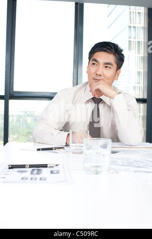Chinese business executive thinking of solutions Stock Photo - Alamy