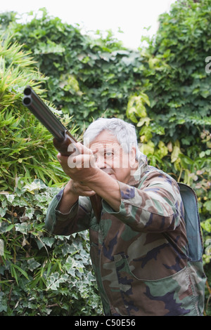 Hunter pointing his rifle Stock Photo - Alamy
