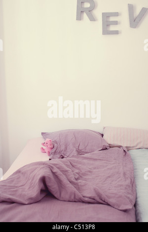 View into bedroom with unmade bed Stock Photo - Alamy