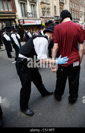 Metropolitan police officers stop and search a group of black youths ...