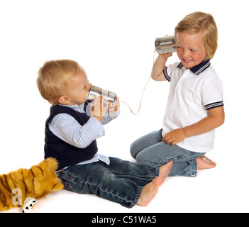 Two brothers talking on a can and string telephone Stock Photo - Alamy