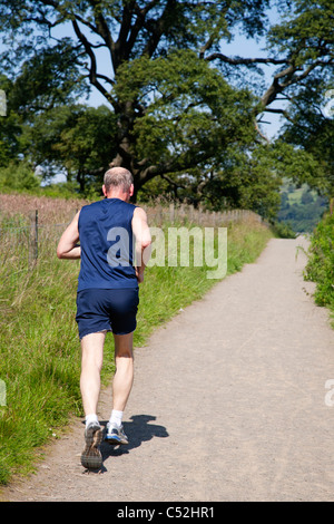 a older man is running on a track in the park, a running man, running ...