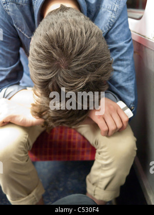 Young Depressed Man Slumped in Corner of Darkened Room Stock Photo - Alamy
