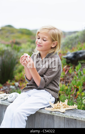 child playing with shells Stock Photo - Alamy