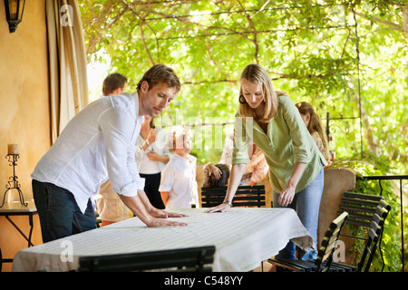 Preparing the dining table Stock Photo - Alamy