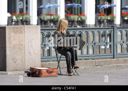 Female street performer playing the accordion, Quebec City, Quebec ...