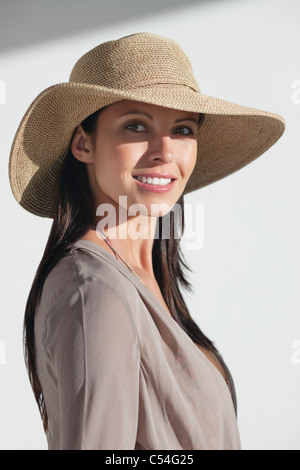 A woman wearing a sun protection clothing walks at an outdoor shopping ...
