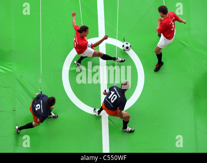 Football players hanging on ropes are pictured at a vertical football ...