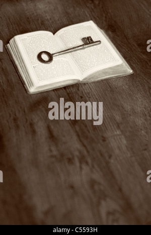 old key over an open book Stock Photo - Alamy