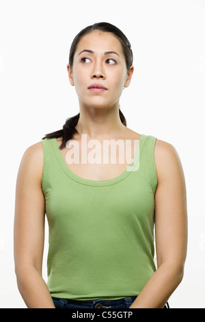 Image of thinking young woman in pink jacket holding eyeglasses ...