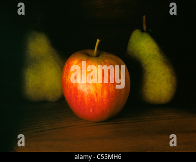 Closeup of two shiny red apples with stems on a white textured surface ...