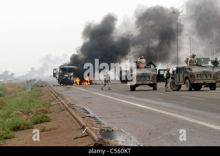 US troops at the scene of bombed out trucks on the Baghdad to Fallujah ...