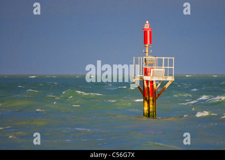 Red port side navigation channel marker illuminated by the sun in a ...