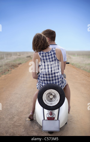 Two people riding a motor scooter towards Trafalgar Square in London ...