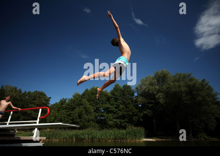 young boy jumping off a diving board Stock Photo - Alamy